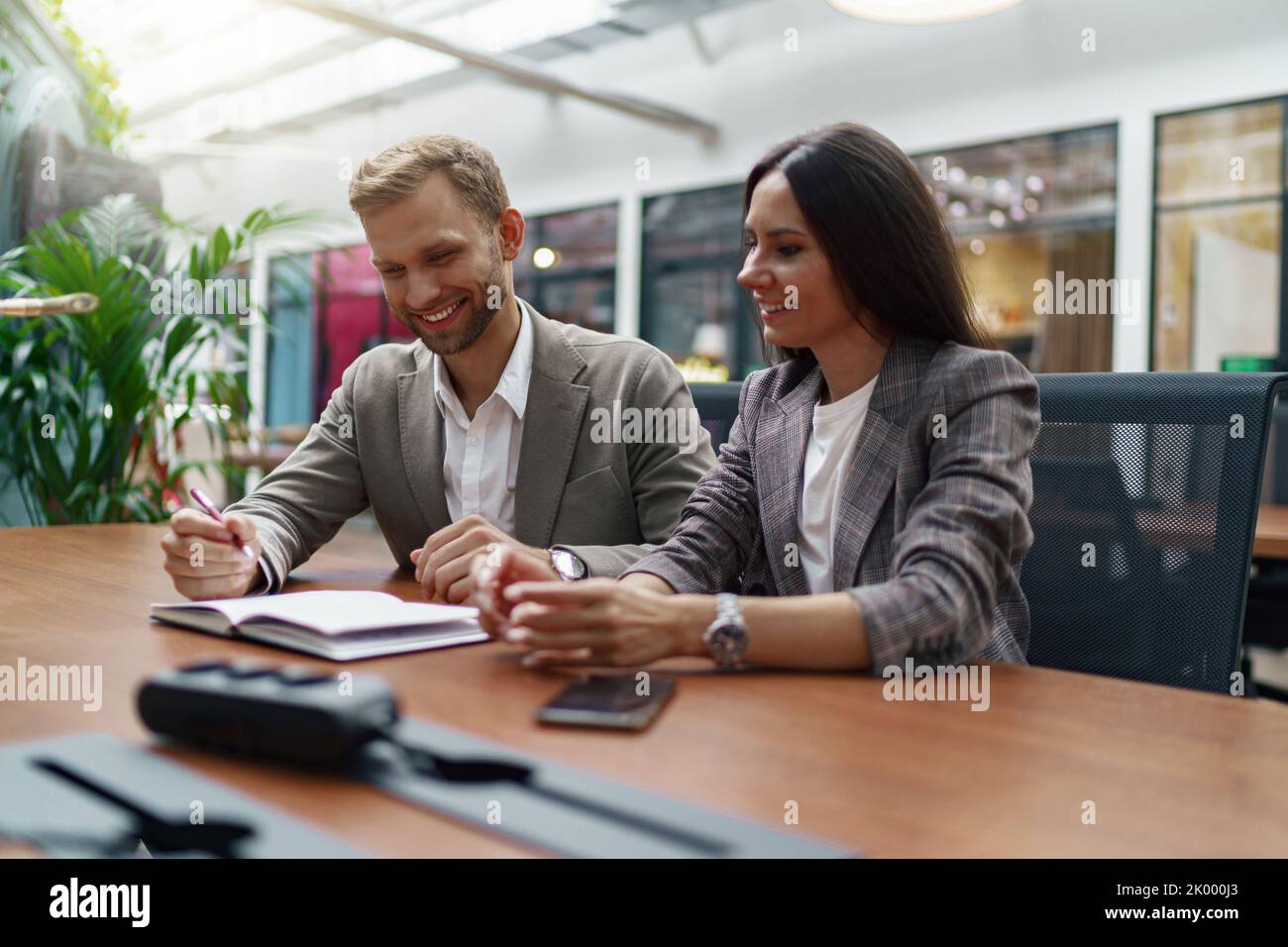 Two businesspartners working together in modern coworking . Teamwork ...