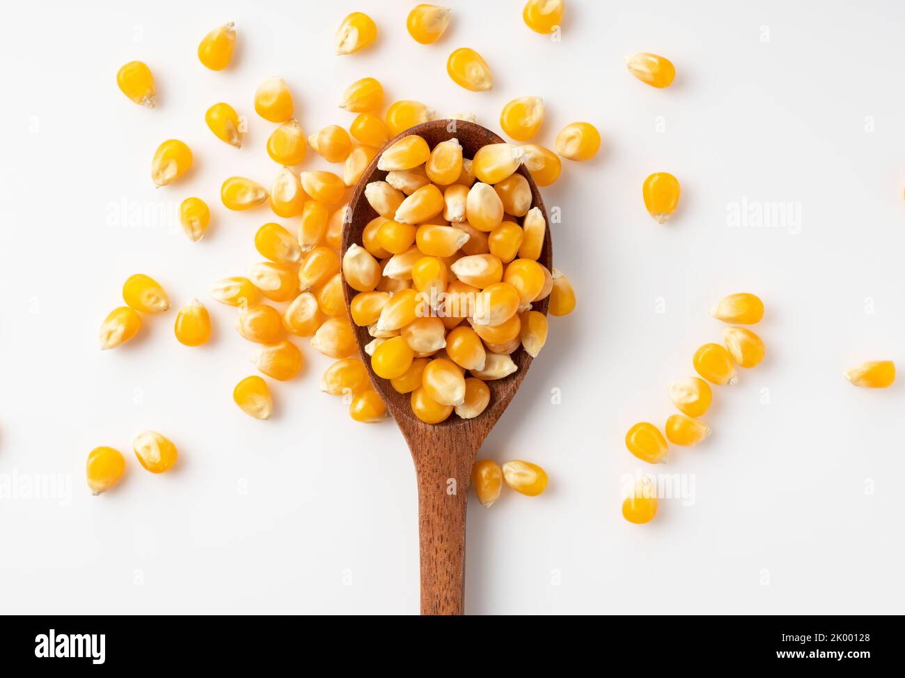 Dried corn kernels and wooden spoon placed on white background. Corn ...