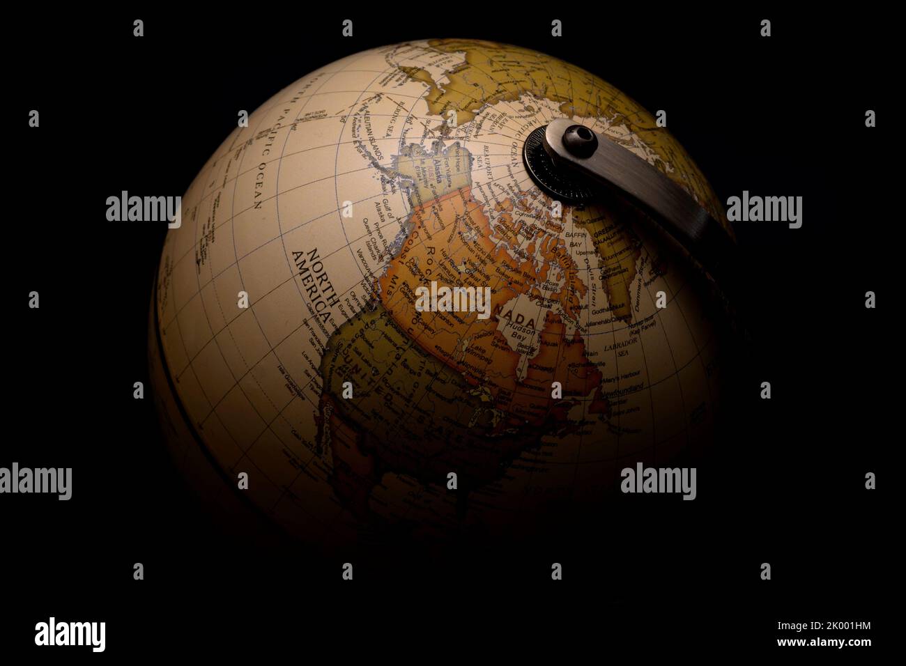 Moody picture of antique spinning globe model surrounded by darkness ...