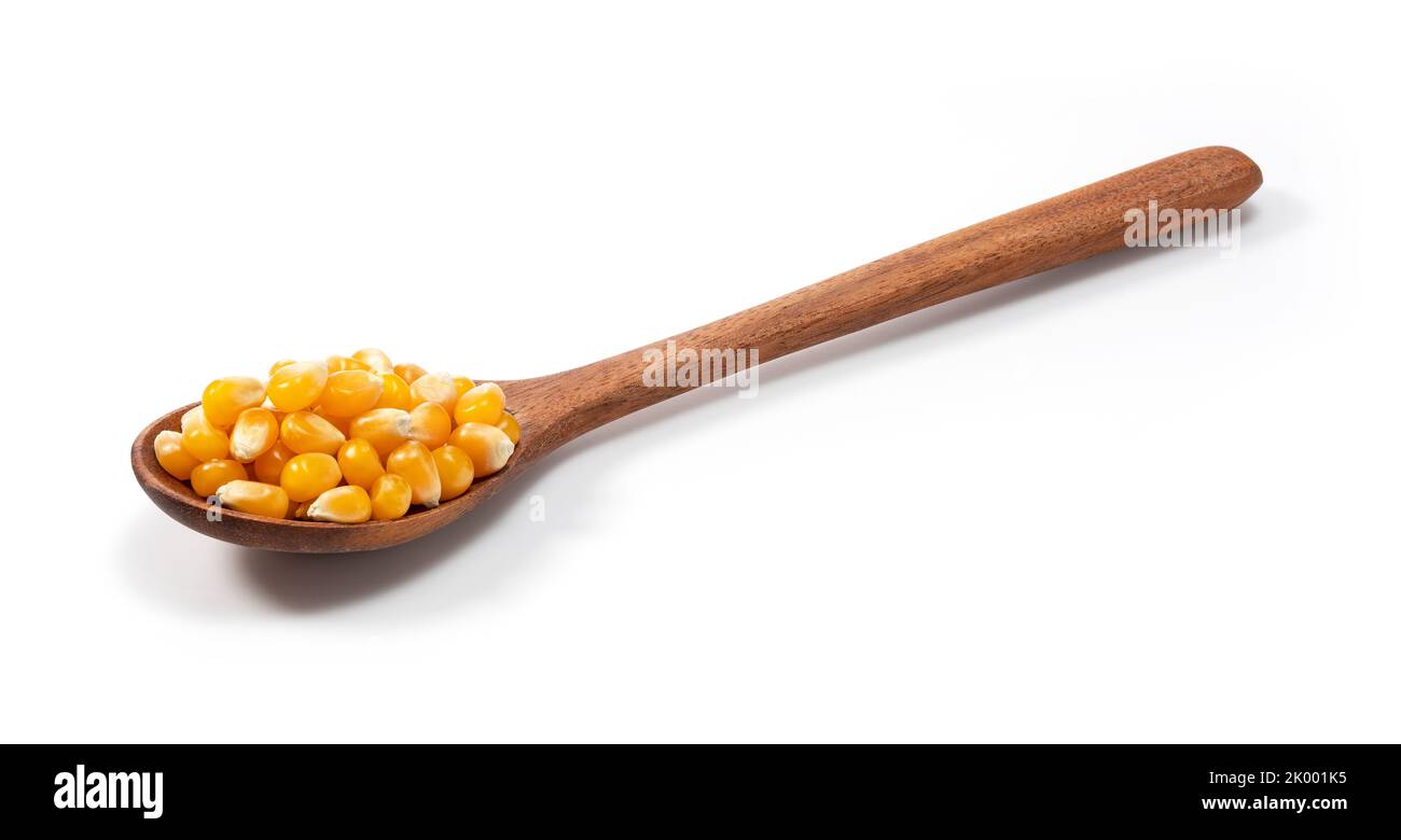 Dried corn kernels and wooden spoon placed on white background. Corn ...
