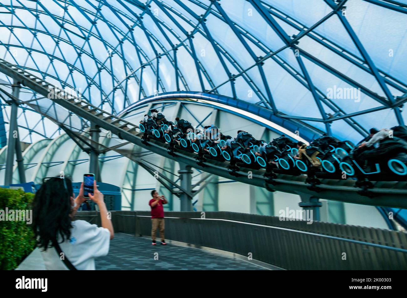 People taking smartphone pictures of the Tron Lightcycle Power Run ride ...