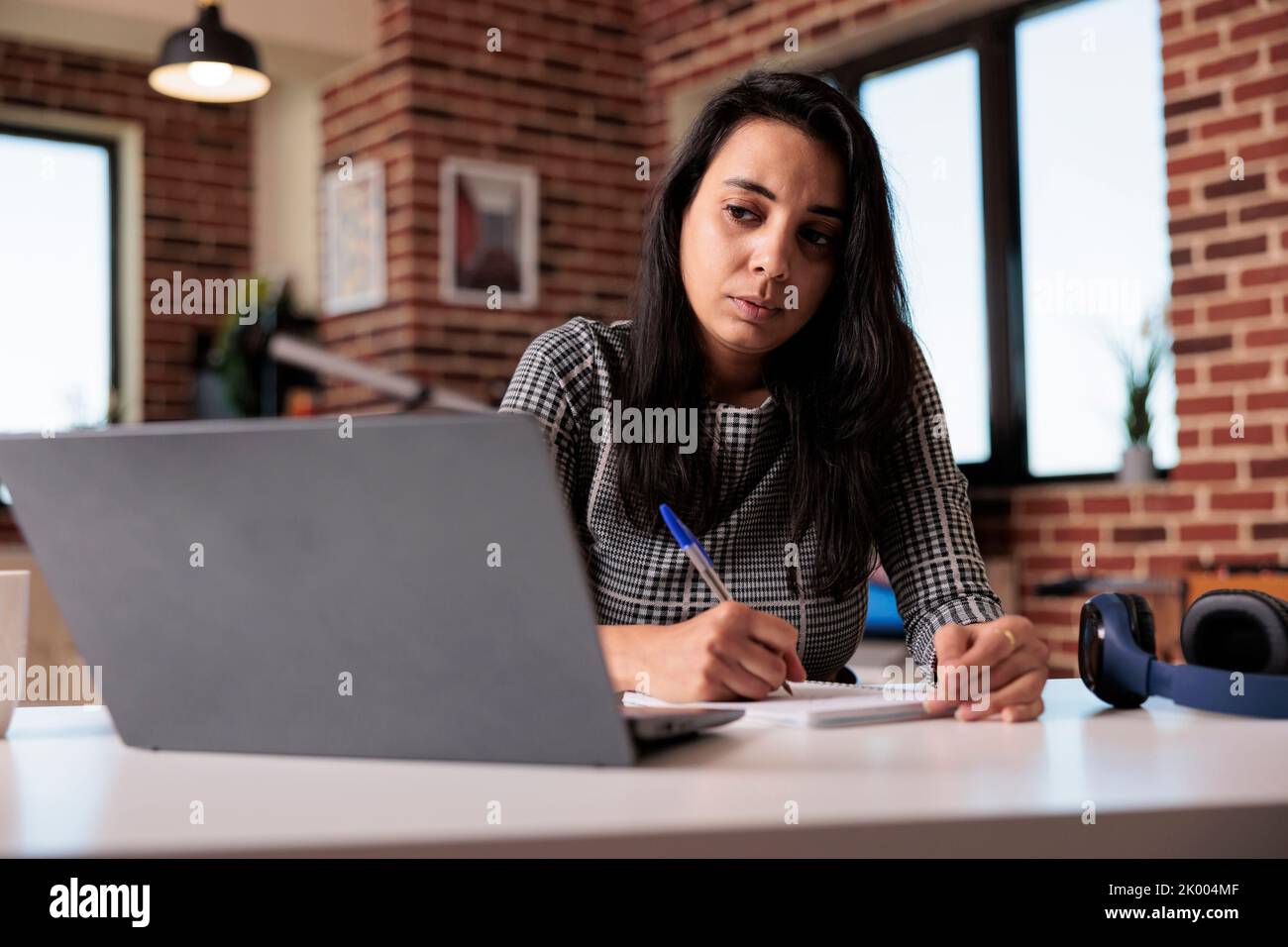 Indian business woman taking paperwork notes on notebook, writing ...