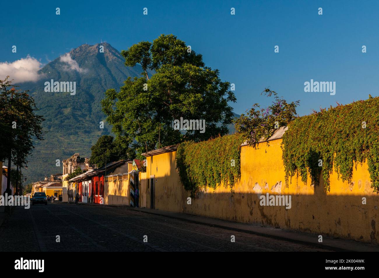 Agua Volcano rises above the streets of Antigua, Guatemala. credit ...