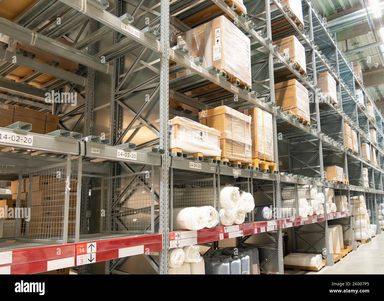 Rows of shelves and racks with goods boxes and items Stock Photo - Alamy