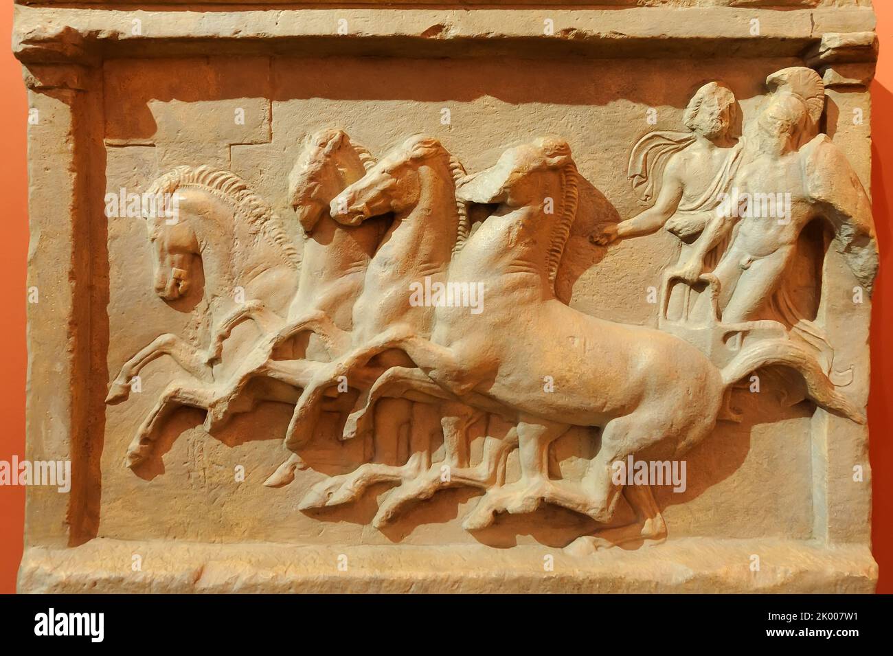 Greek aged ruined stone relief depicting men on chariot Stock Photo - Alamy