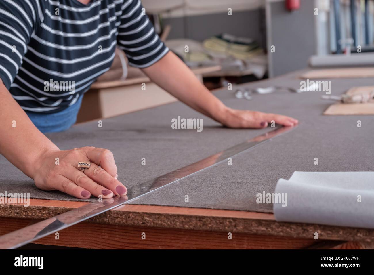 The cutter marks the fabric for cutting in the sewing workshop Stock ...