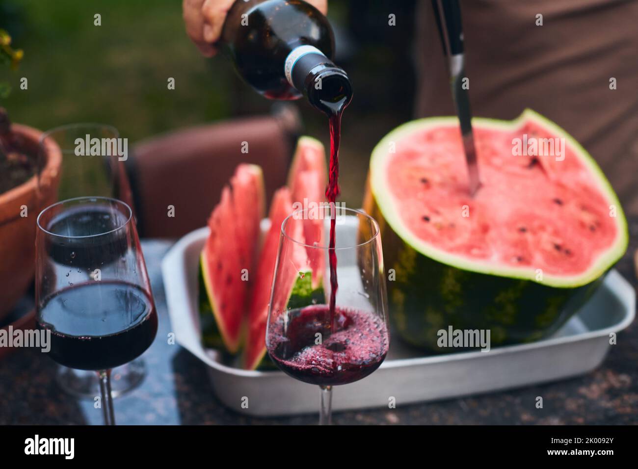 Juicy red watermelon and red wine. The concept of summer and delicious ...
