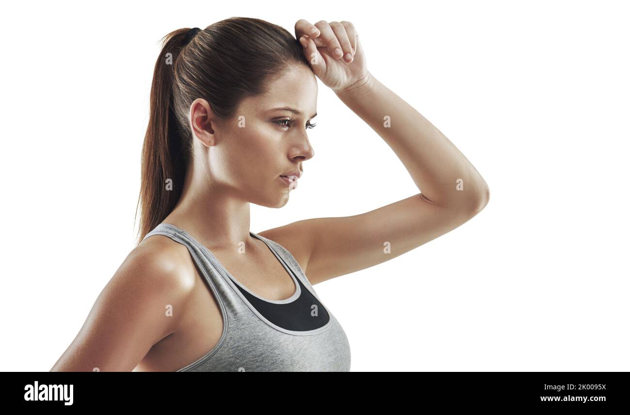 What a tough workout. a young female athlete wiping the sweat from her ...