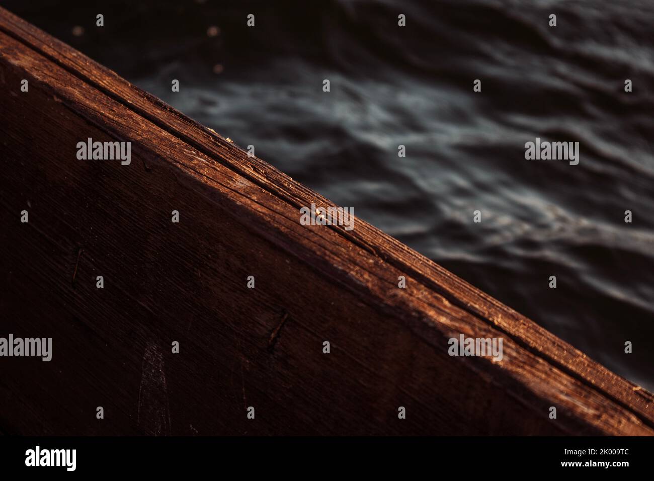 Side view of wooden boat on calm lake Stock Photo - Alamy