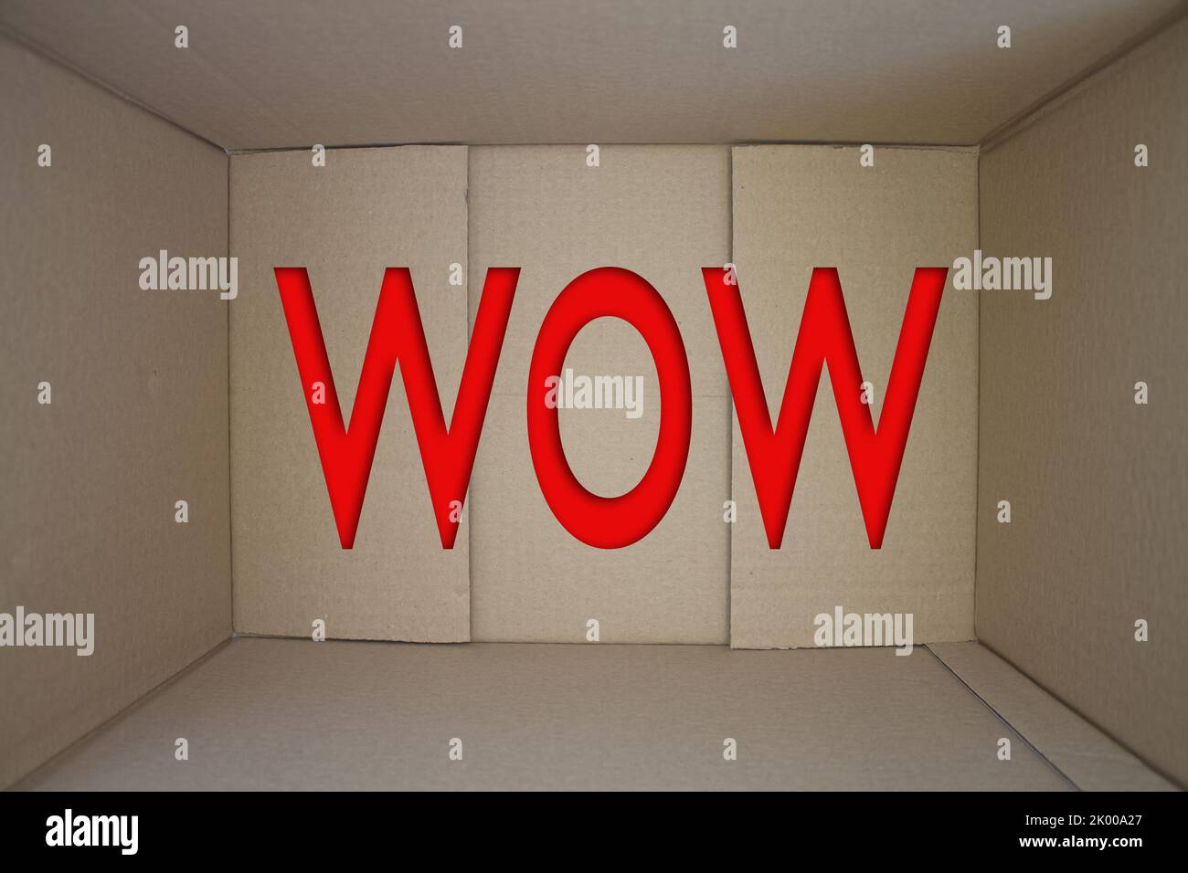 Wow word with cardboard box. Brown folded card box Stock Photo - Alamy