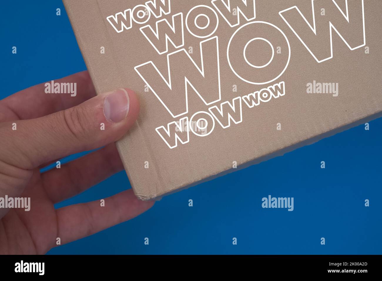 Wow word with cardboard box. Brown folded card box Stock Photo - Alamy