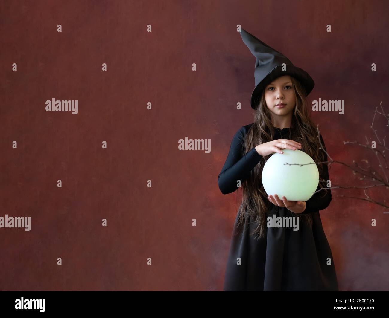 The witch with magic ball in her hands causes a spirits in cave. High ...