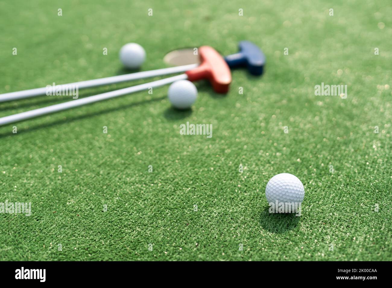 Close-up of miniature golf hole with bat and ball Stock Photo - Alamy