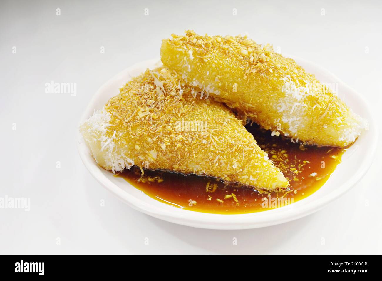 Kueh Lopes is a triangle-shape sticky rice dumpling, served with grated ...