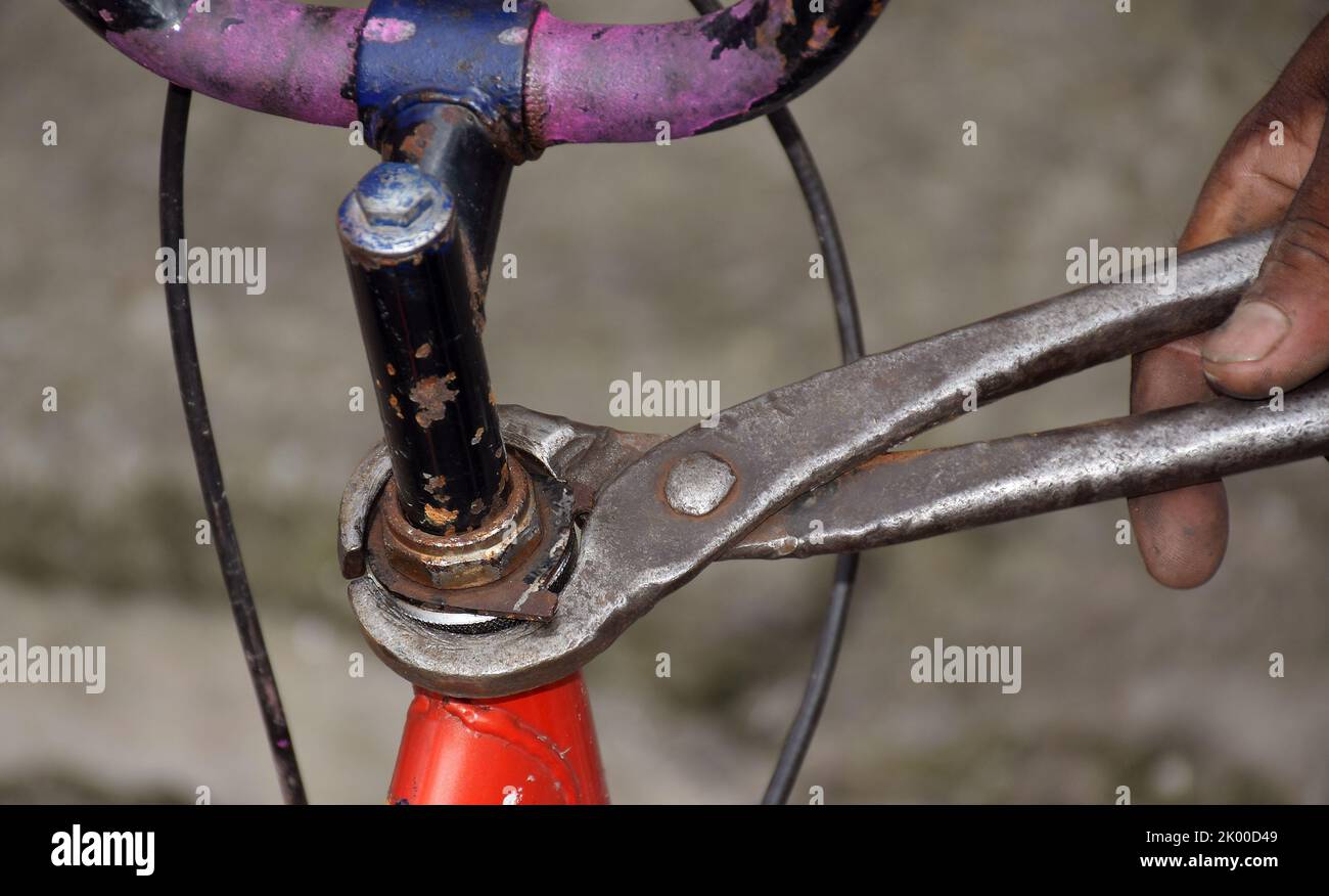 Hand of a cycle mechanic tightening a cycle screw with his Iron Wrench ...