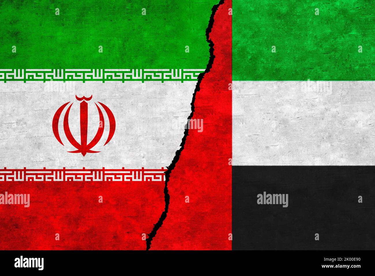 Iran and United Arab Emirates flags on a wall with a crack. UAE and ...