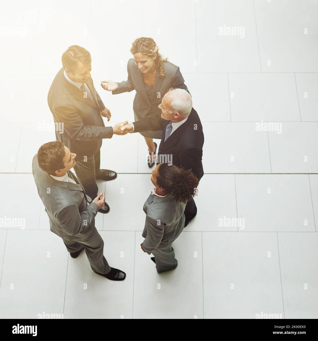 Joining forces. High angle shot of two groups of business teams meeting ...