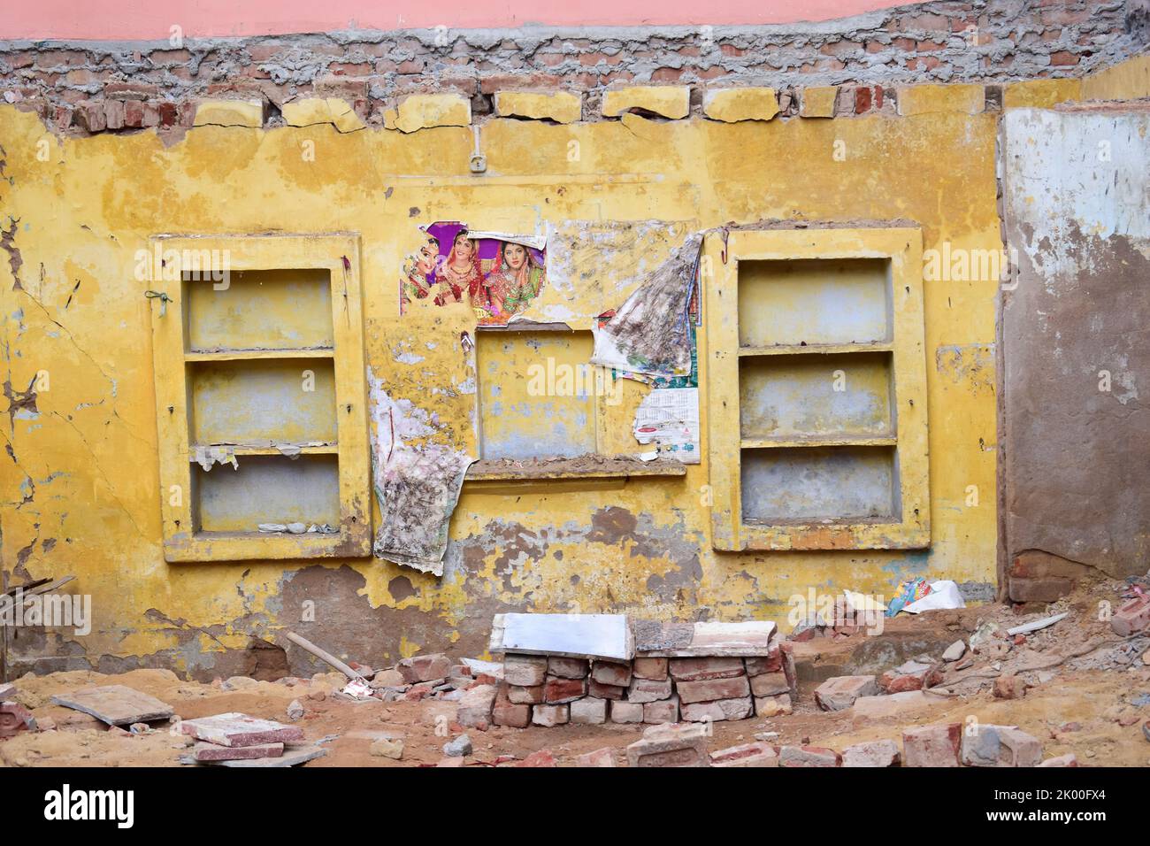 Yellow wall of a damaged building. Concept - indian street photography ...