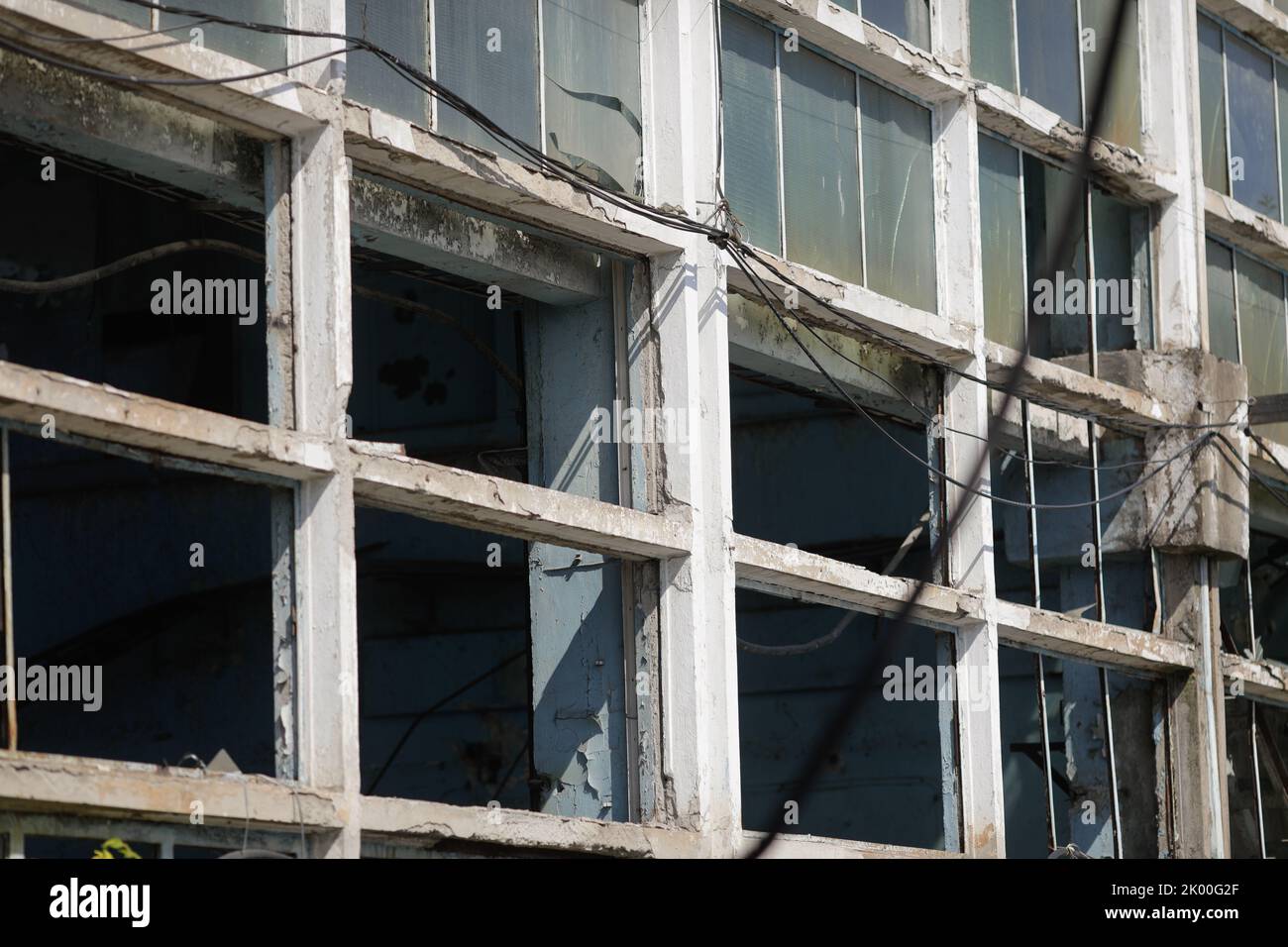 Broken walls and windows in an abandoned industrial building Stock Photo - Alamy