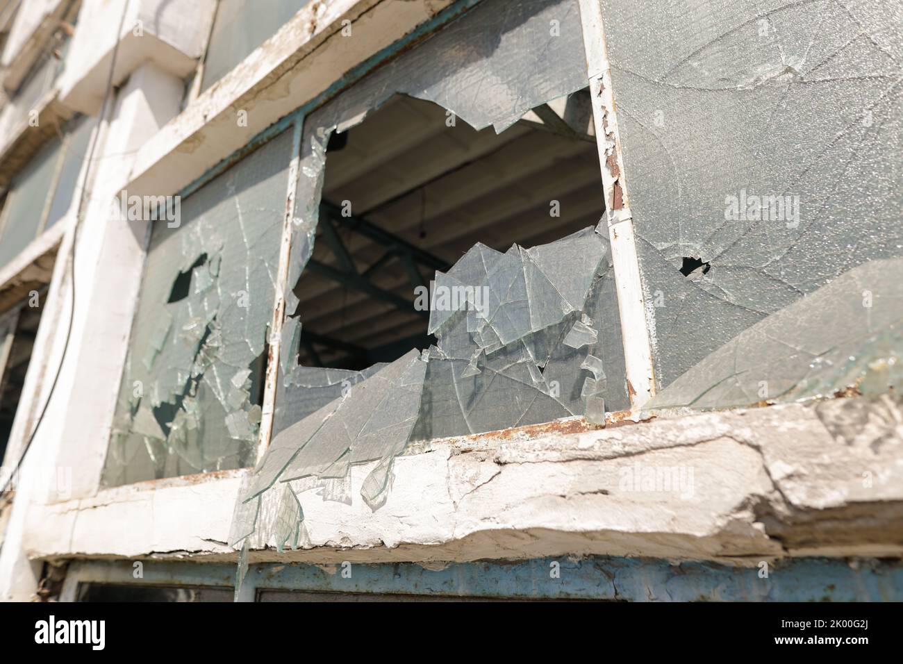 Broken walls and windows in an abandoned industrial building Stock Photo - Alamy