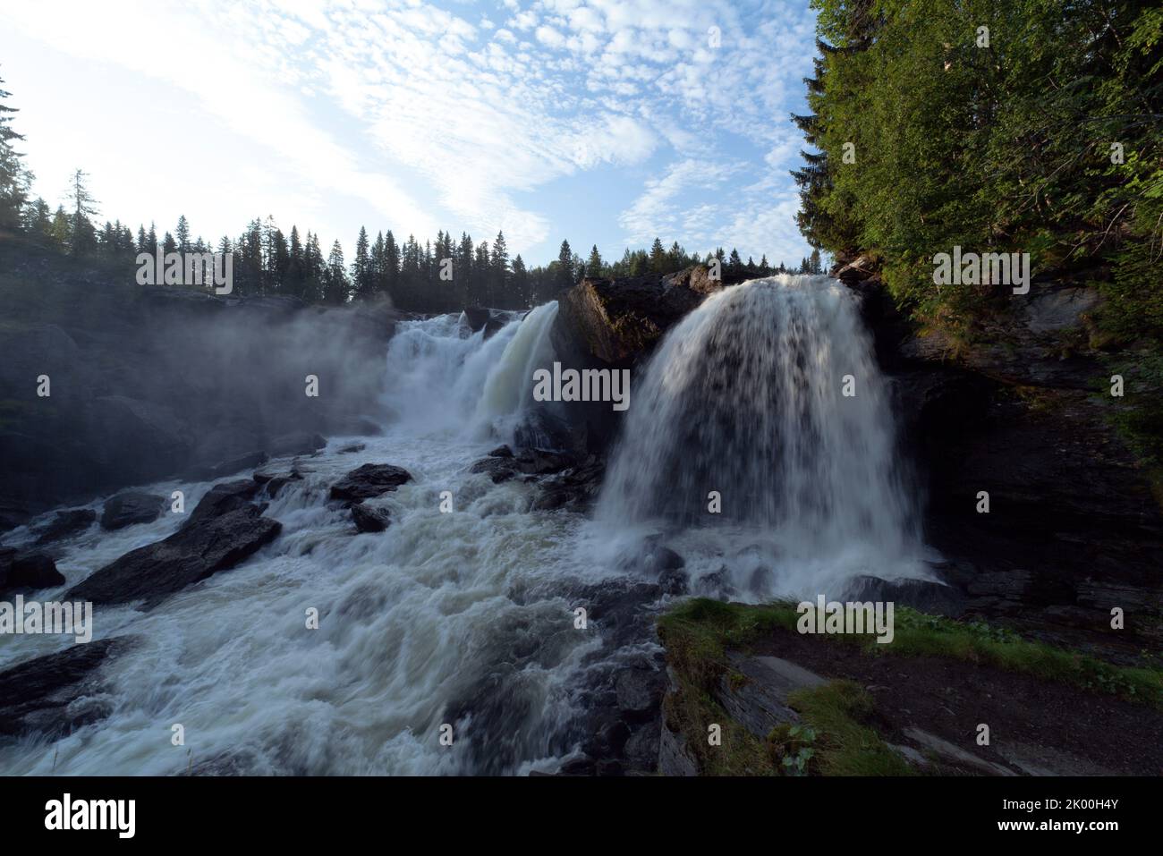 Waterfall in a mighty river in the woodland, mountain. Rocks, cliffs ...