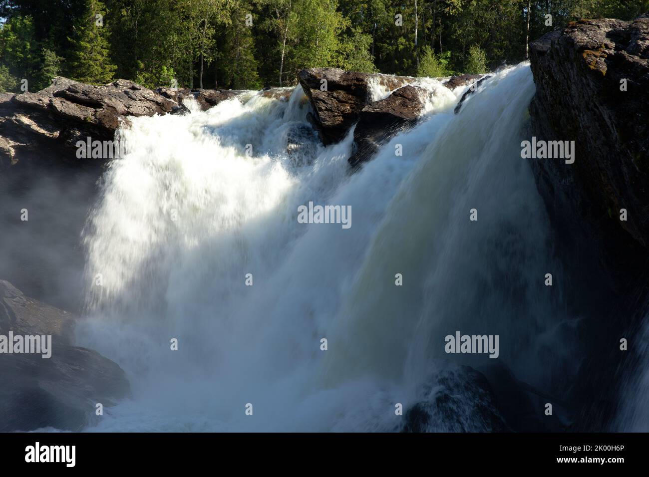 Waterfall in a mighty river in the woodland, mountain. Rocks, cliffs ...