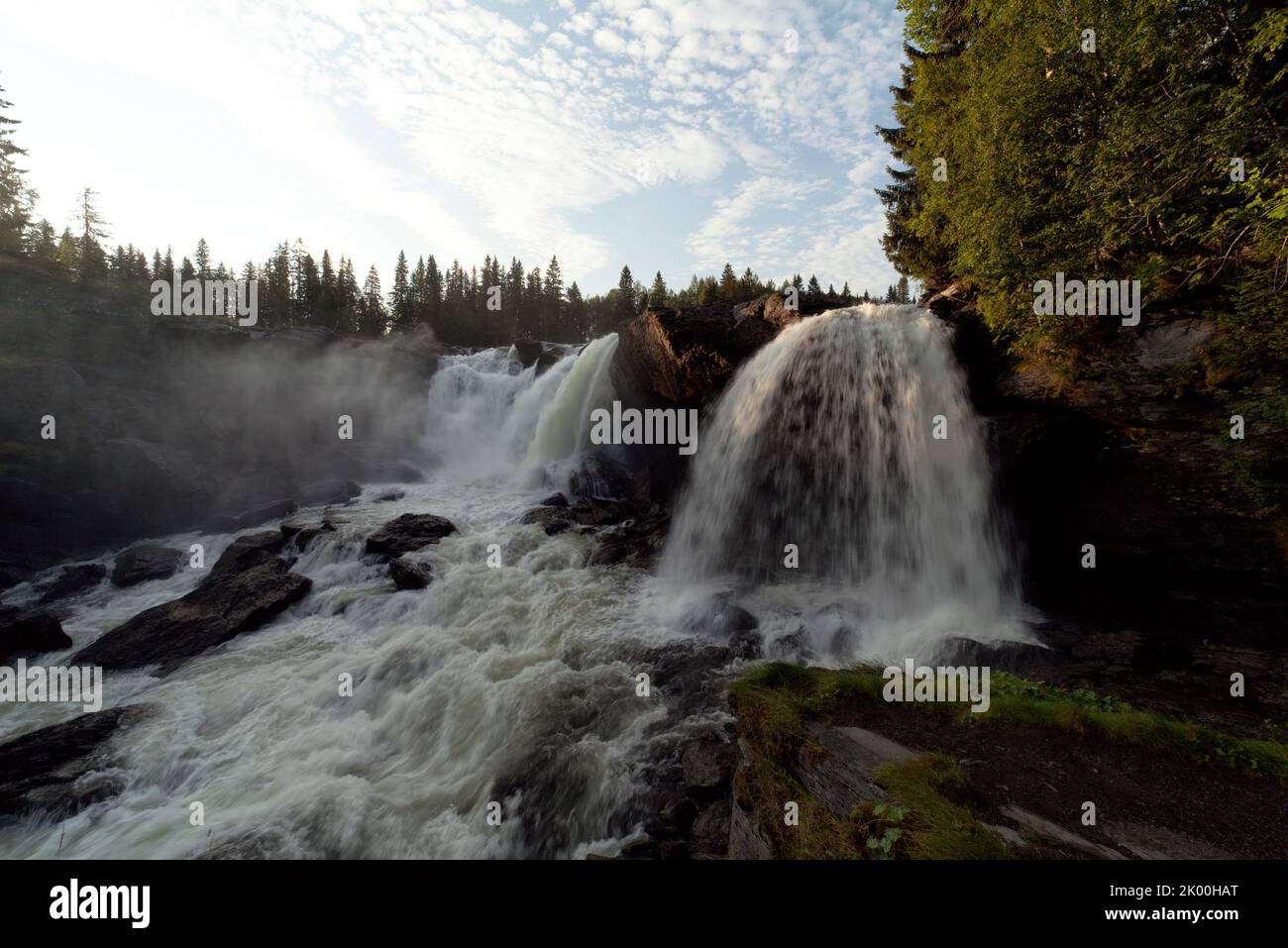 Waterfall in a mighty river in the woodland, mountain. Rocks, cliffs ...