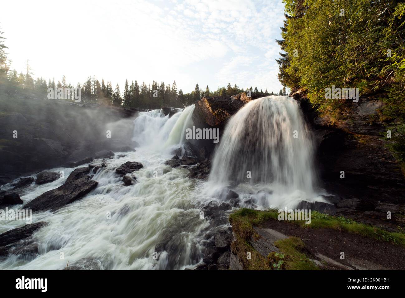 Waterfall in a mighty river in the woodland, mountain. Rocks, cliffs ...
