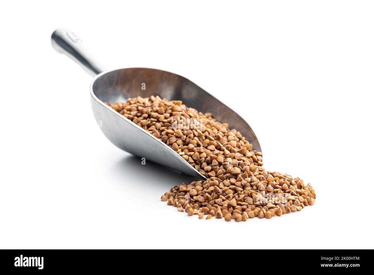 Uncooked buckwheat grain in scoop isolated on the white background ...