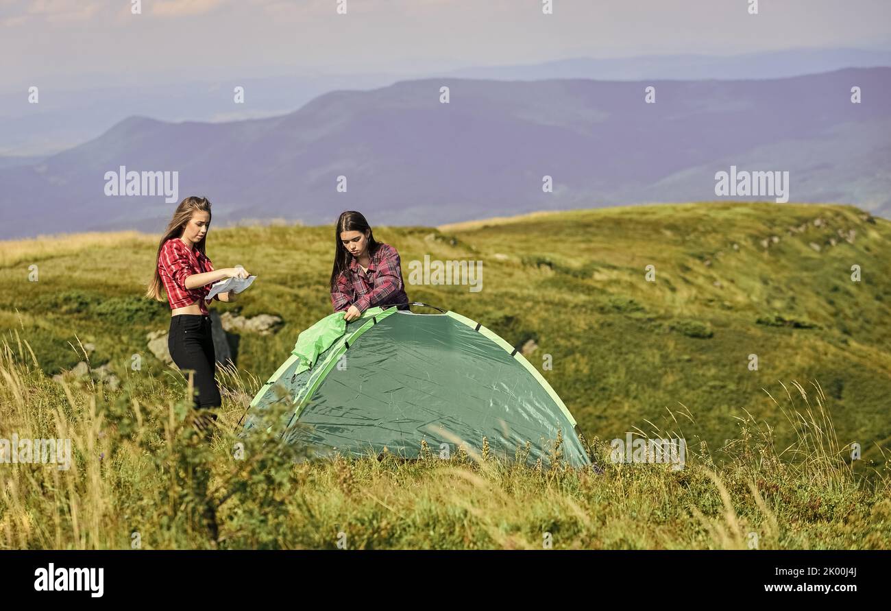 Follow instructions. Group friends set up tent on top mountain ...