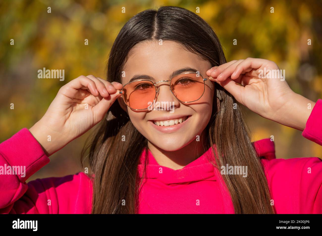 cheerful teen girl outdoor in autumn season wearing sunglasses Stock ...