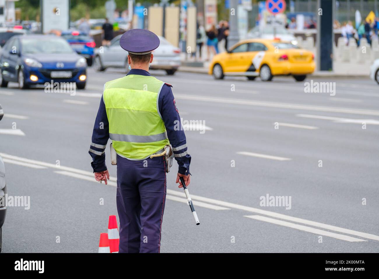 Back view of anonymous man in traffic police uniform and safety vest ...