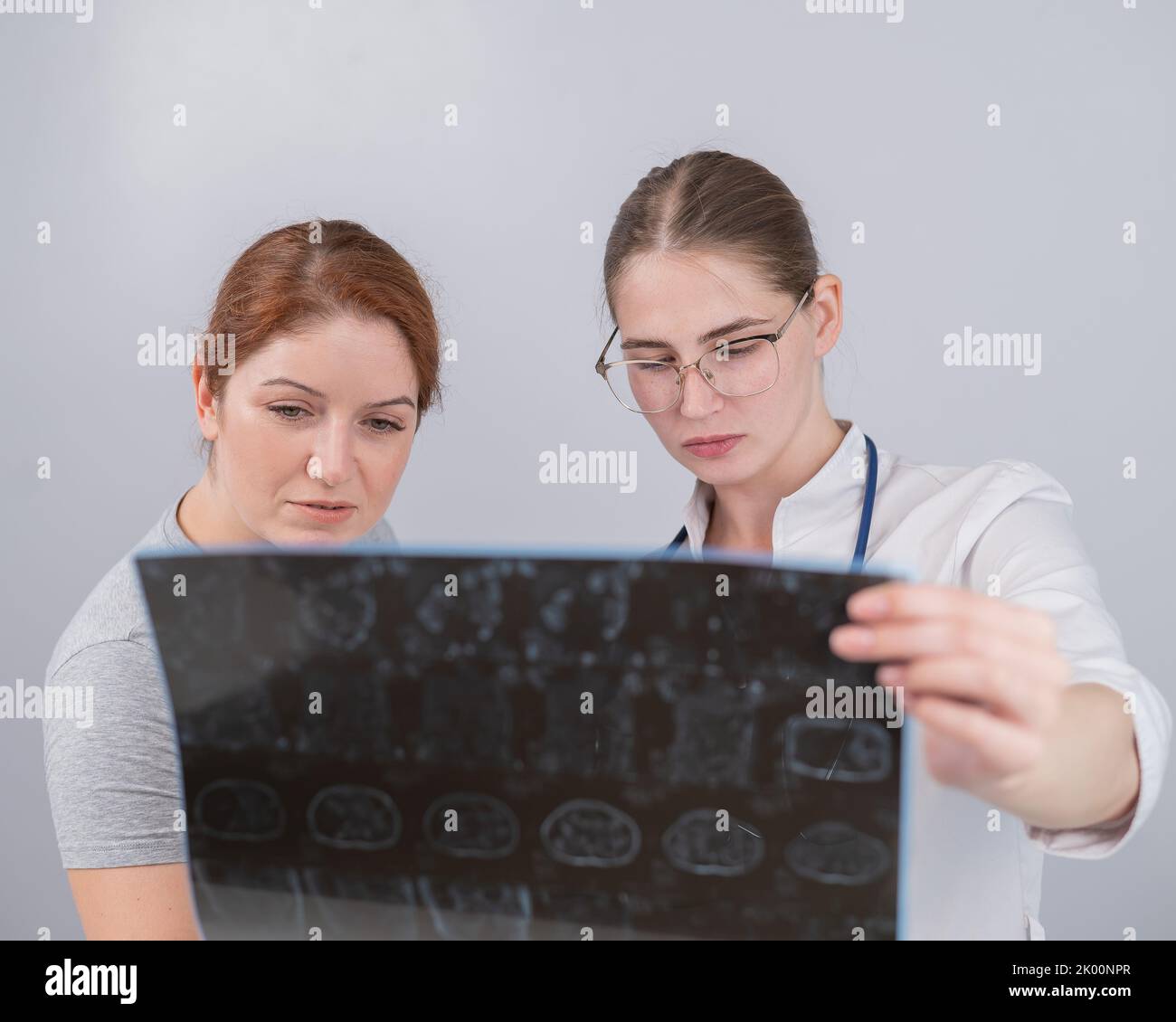 Female doctor explaining mri of internal organs to female patient Stock ...