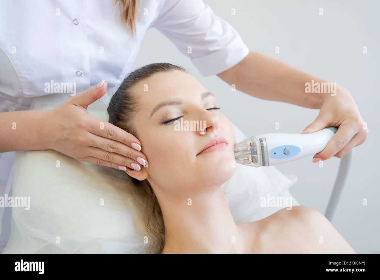 Handle radio frequency apparatus on chin woman's face during skin ...