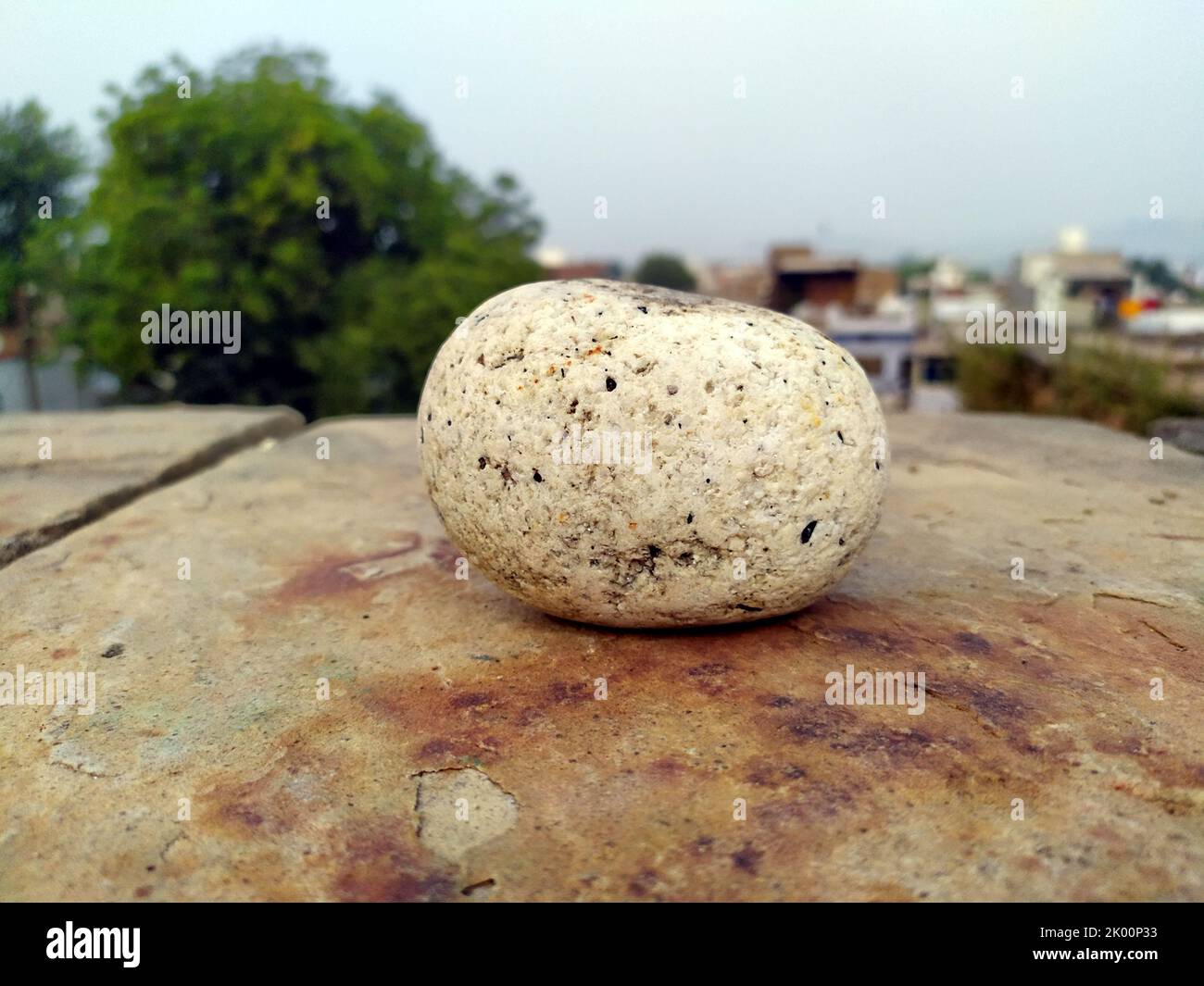 a white round stone put on the road Stock Photo - Alamy