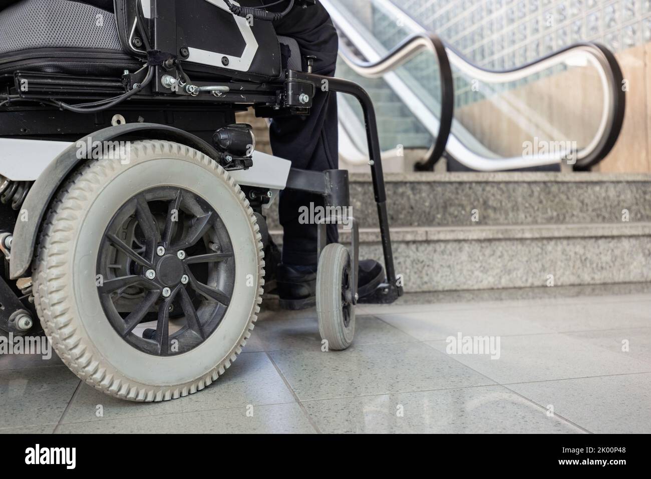 Person with disability on electric wheelchair stopping at the bottom of ...