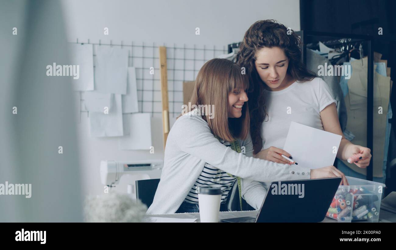 Team of two creative female designers is choosing color of sewing ...