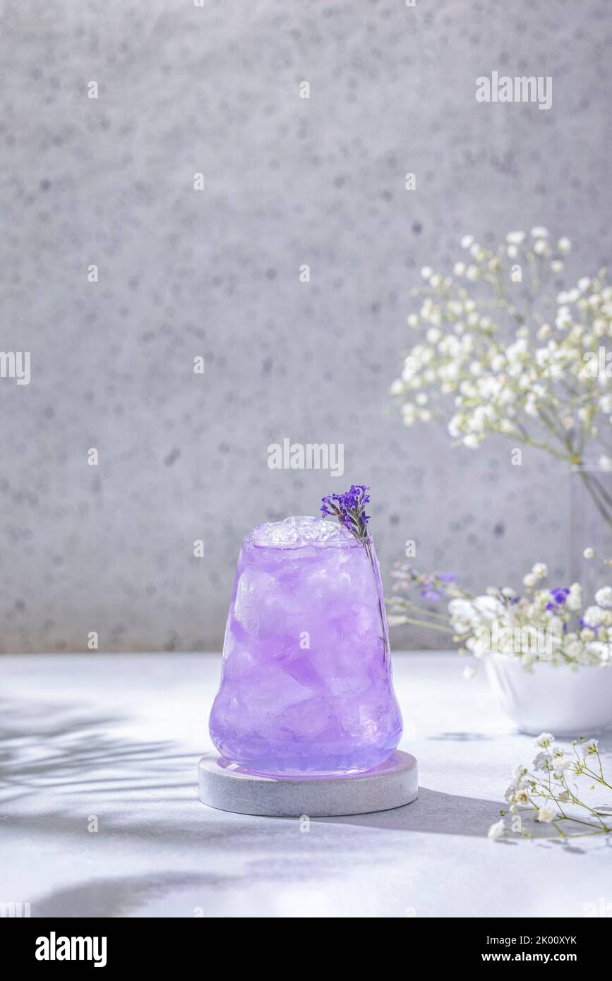 Lavender Gin and Tonic Punch Cocktail. Elegant glass filled with violet ...