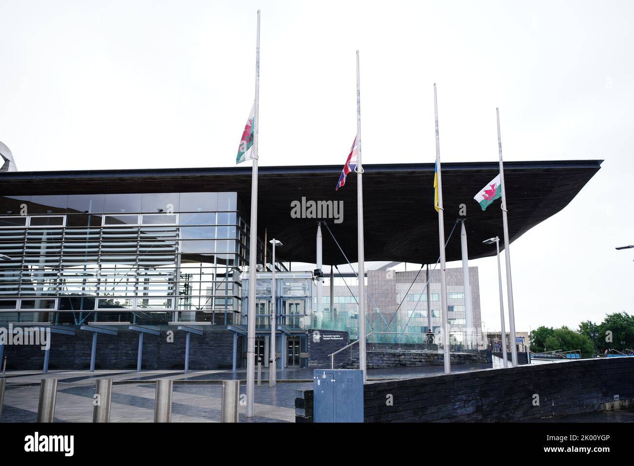 Flags fly at half mast outside the Senedd Building in Cardiff, Wales ...