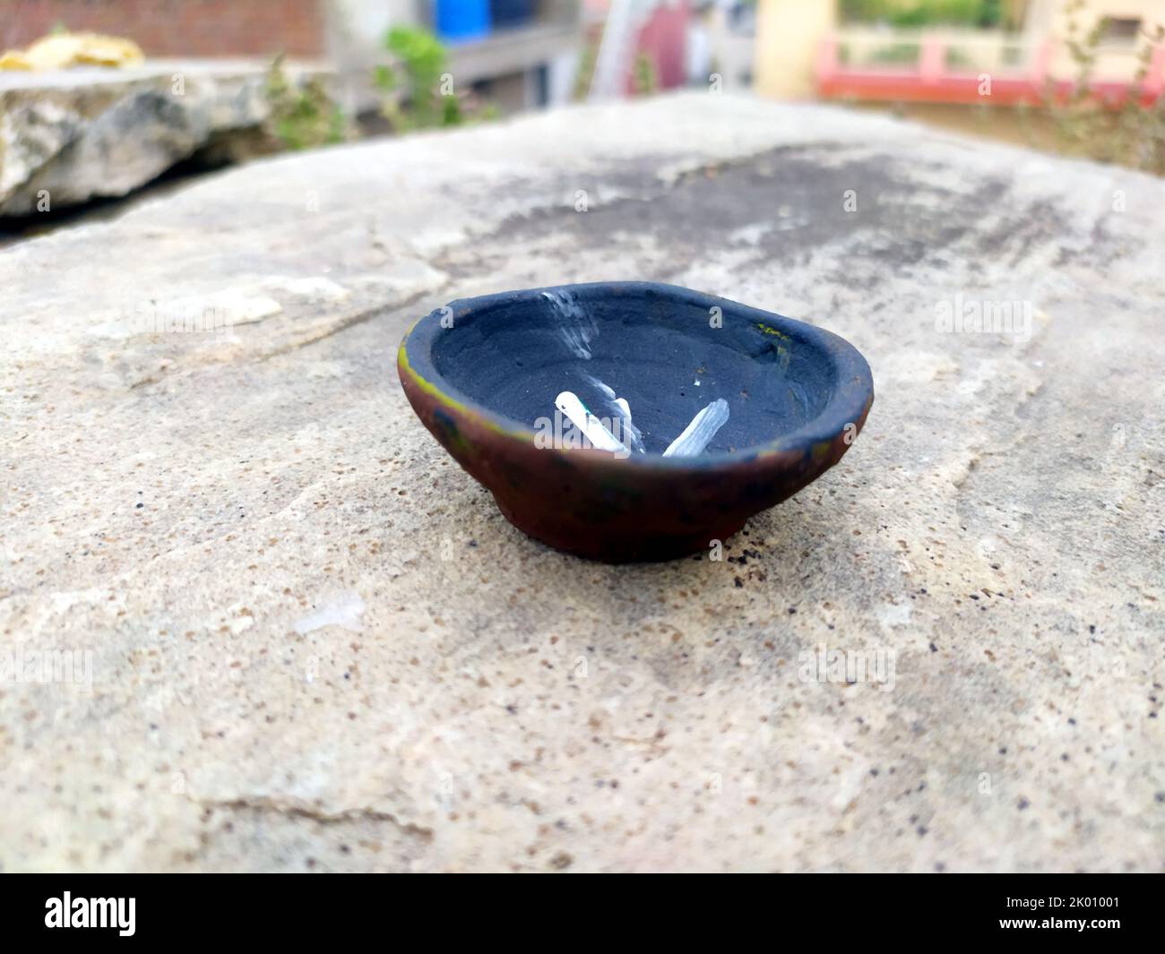 oil clay lamp put on a big stone Stock Photo - Alamy