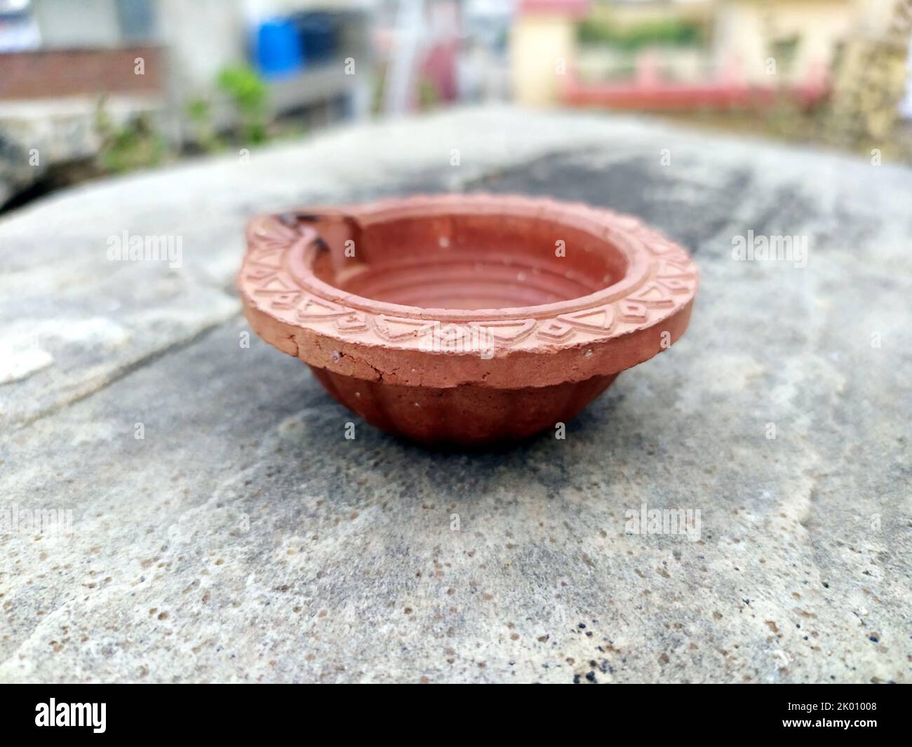 oil clay lamp put on a big stone Stock Photo - Alamy