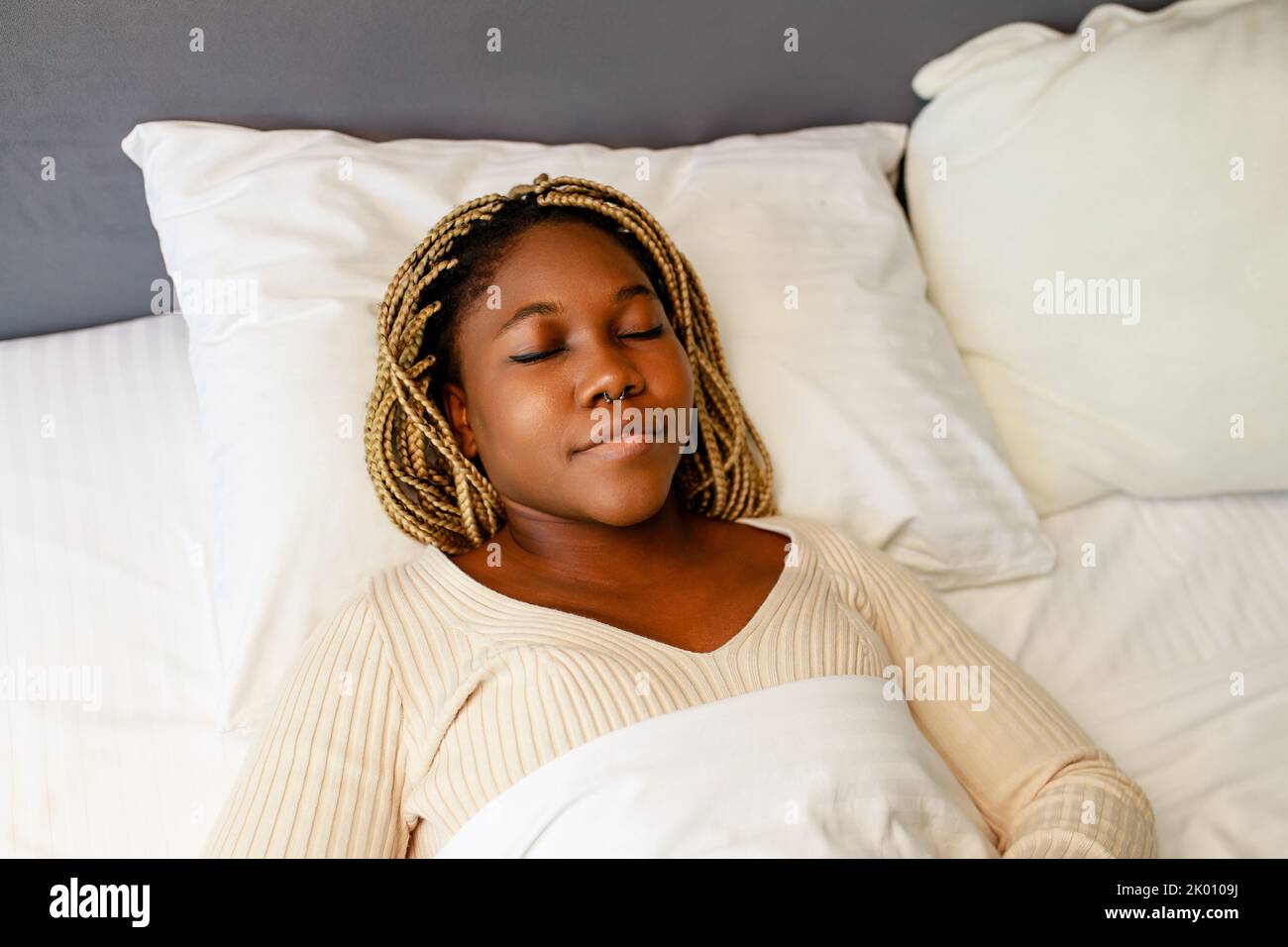 Afro american female keeping eyes closed while sleeping at the bedroom Stock Photo - Alamy