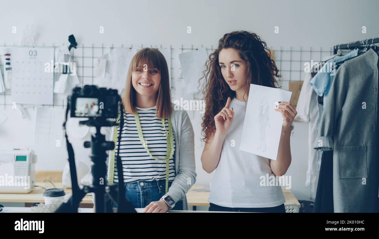 Young attractive vloggers clothing designers are recording video for ...