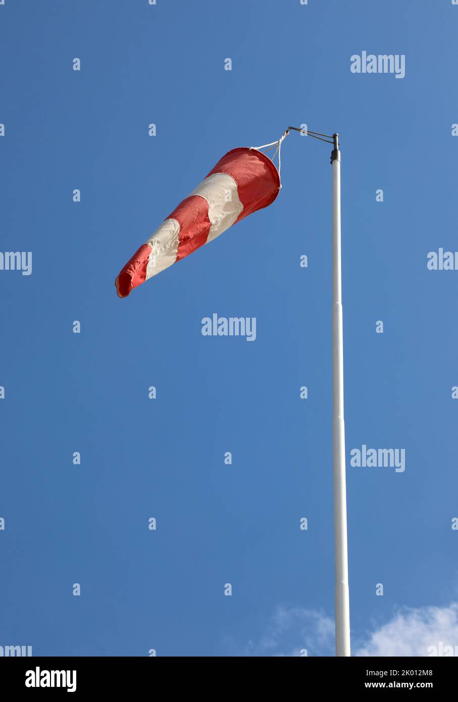red and white windsock to indicate the direction of the air flow and ...