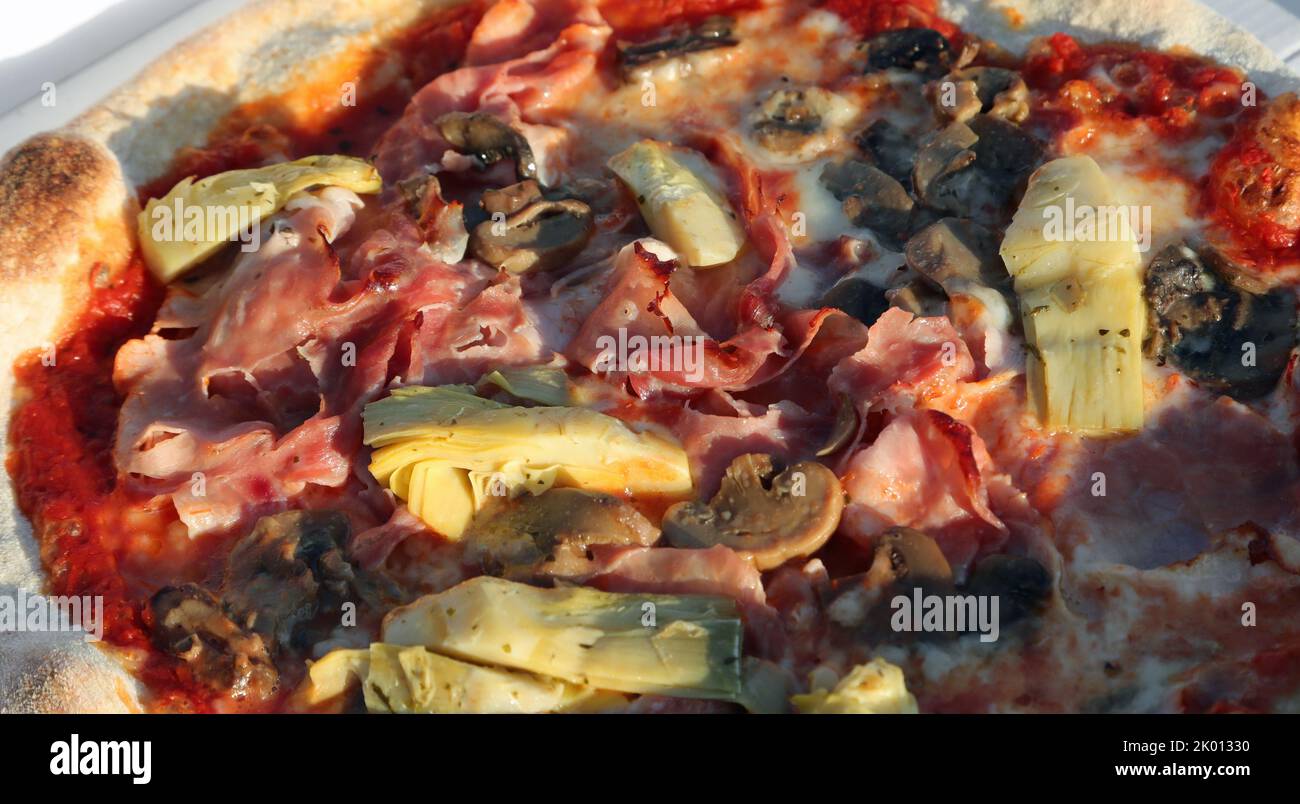 italian pizza with mushrooms ham artichokes cheese mozzarella and ...