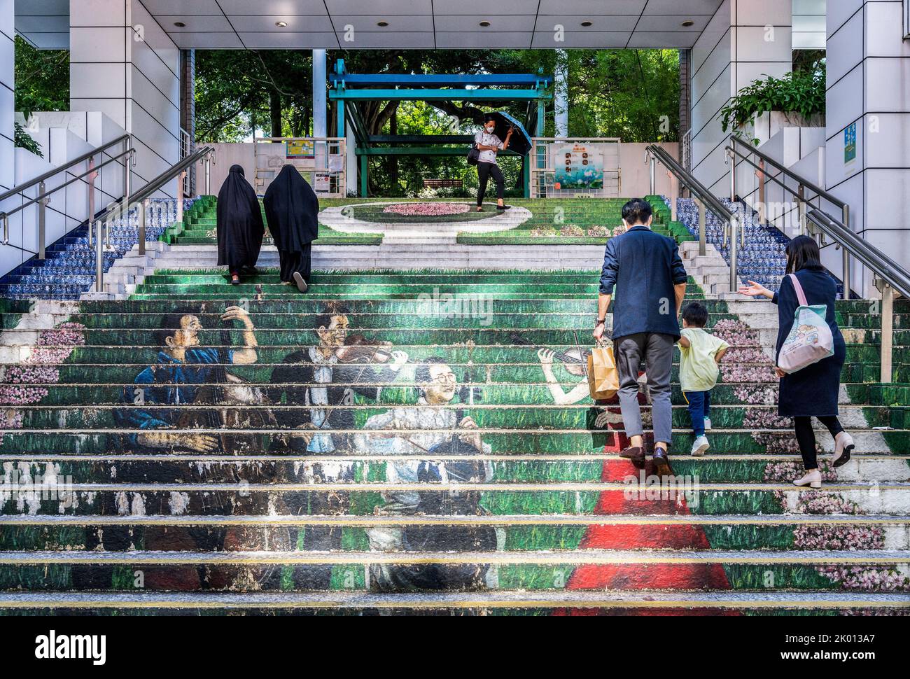 People seen climbing painted mural stairs in Hong Kong. (Photo by ...