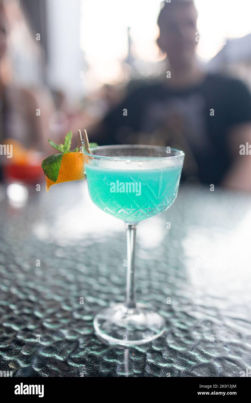 Tasty Blue Lagoon cocktail on light grey table, outdoors Stock Photo ...