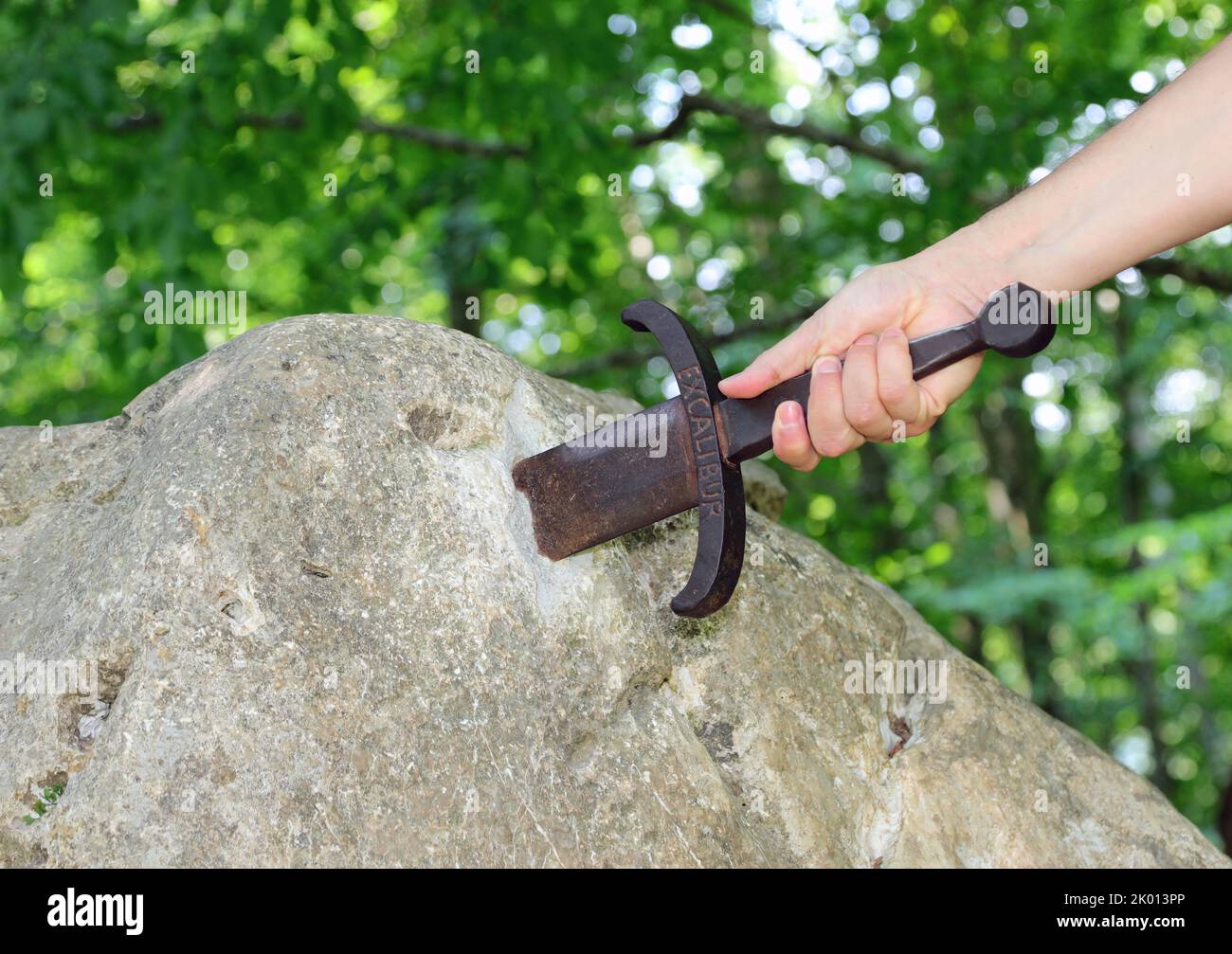 hand of the knight who tries to extract the Excalibur Sword stuck in ...