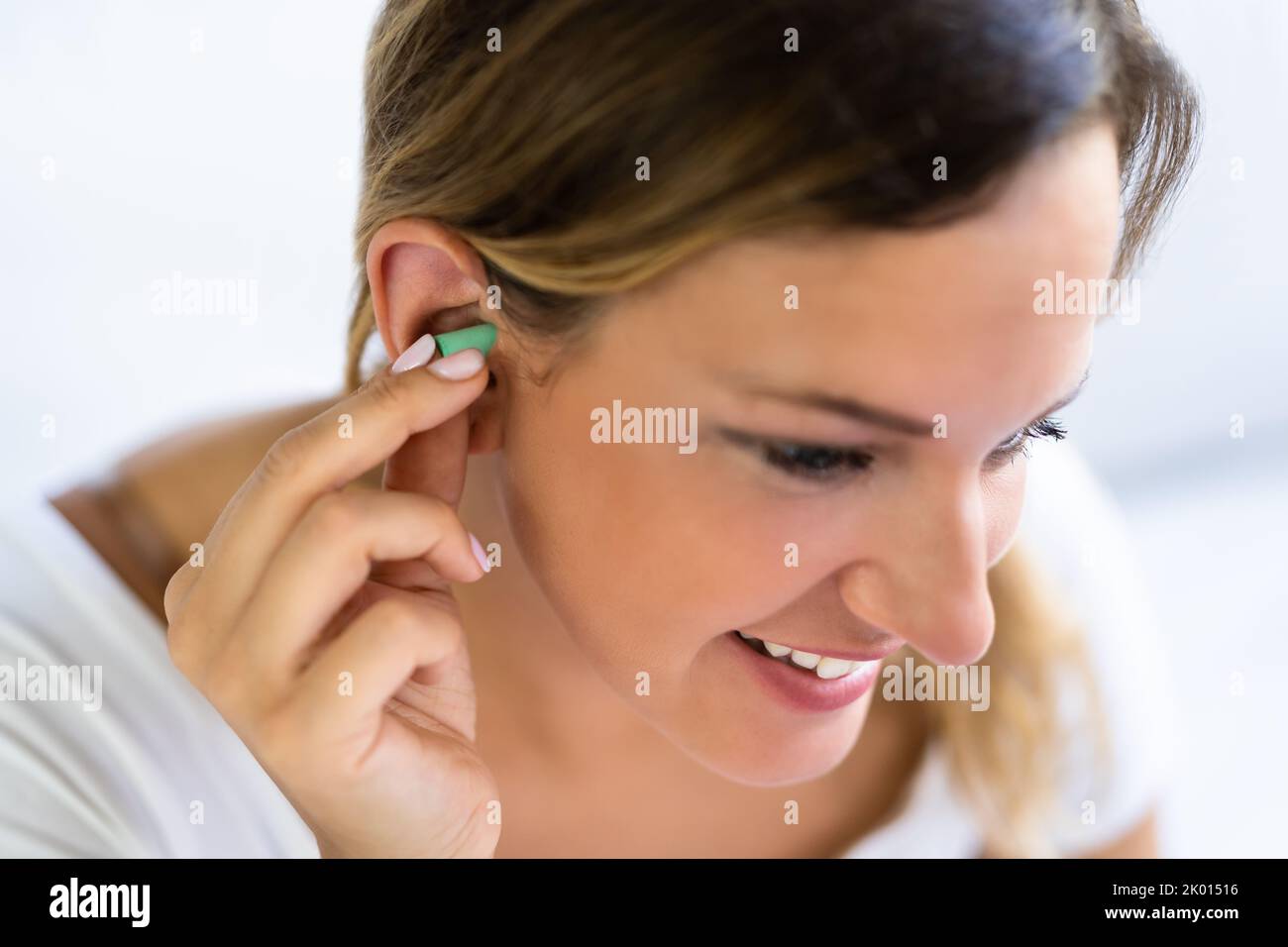 Woman Using Ears Stoppers In Home Bedroom Stock Photo - Alamy