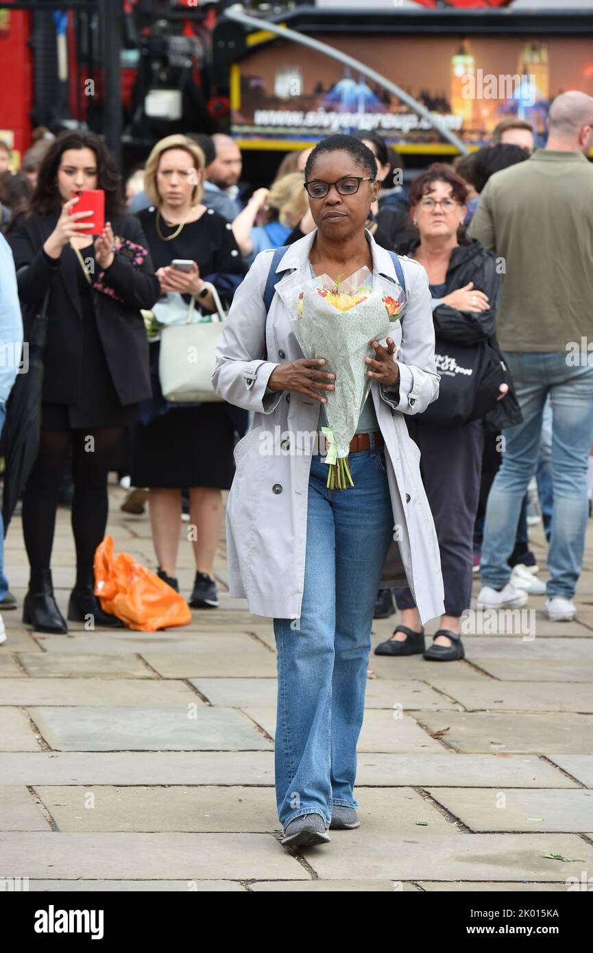London, UK. 9th Sep, 2022. A woman walks to lay flowers at the gates of ...